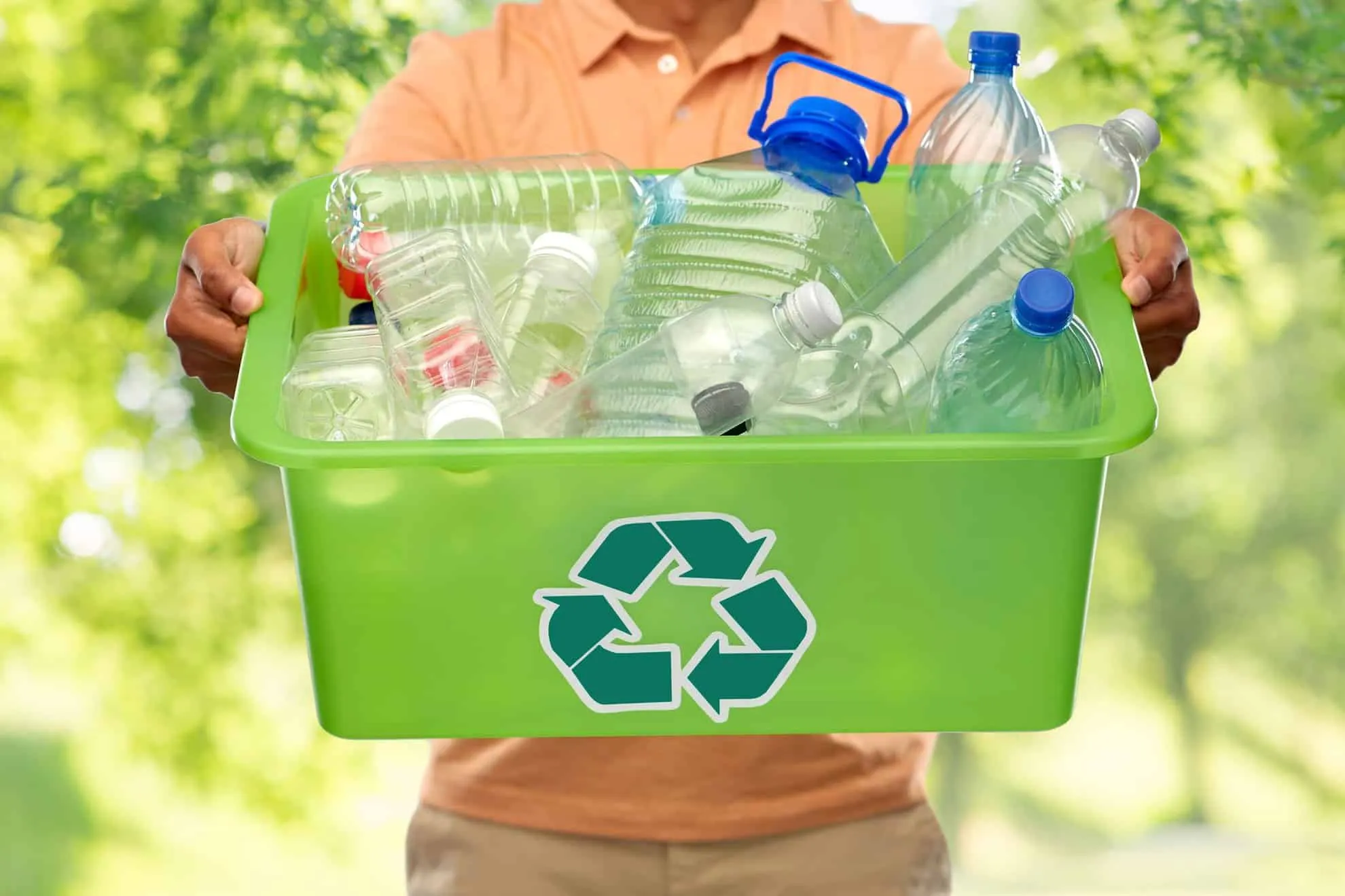 close up of young man sorting plastic waste - greenery.